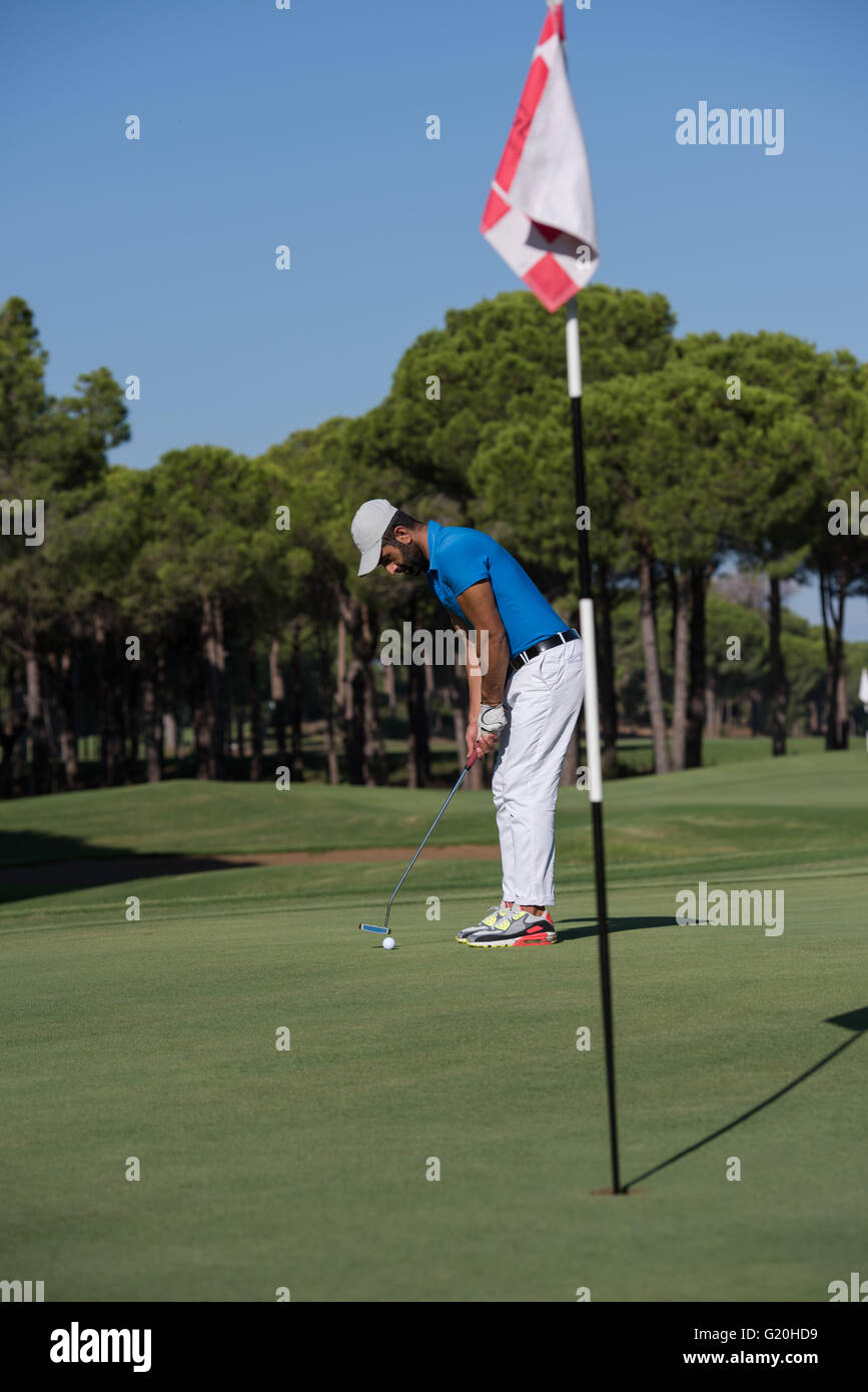 golf player hitting shot with driver on course at beautiful sunny day ...