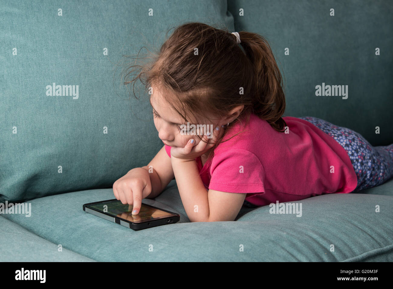 Toddler playing games on a cell phone Stock Photo - Alamy