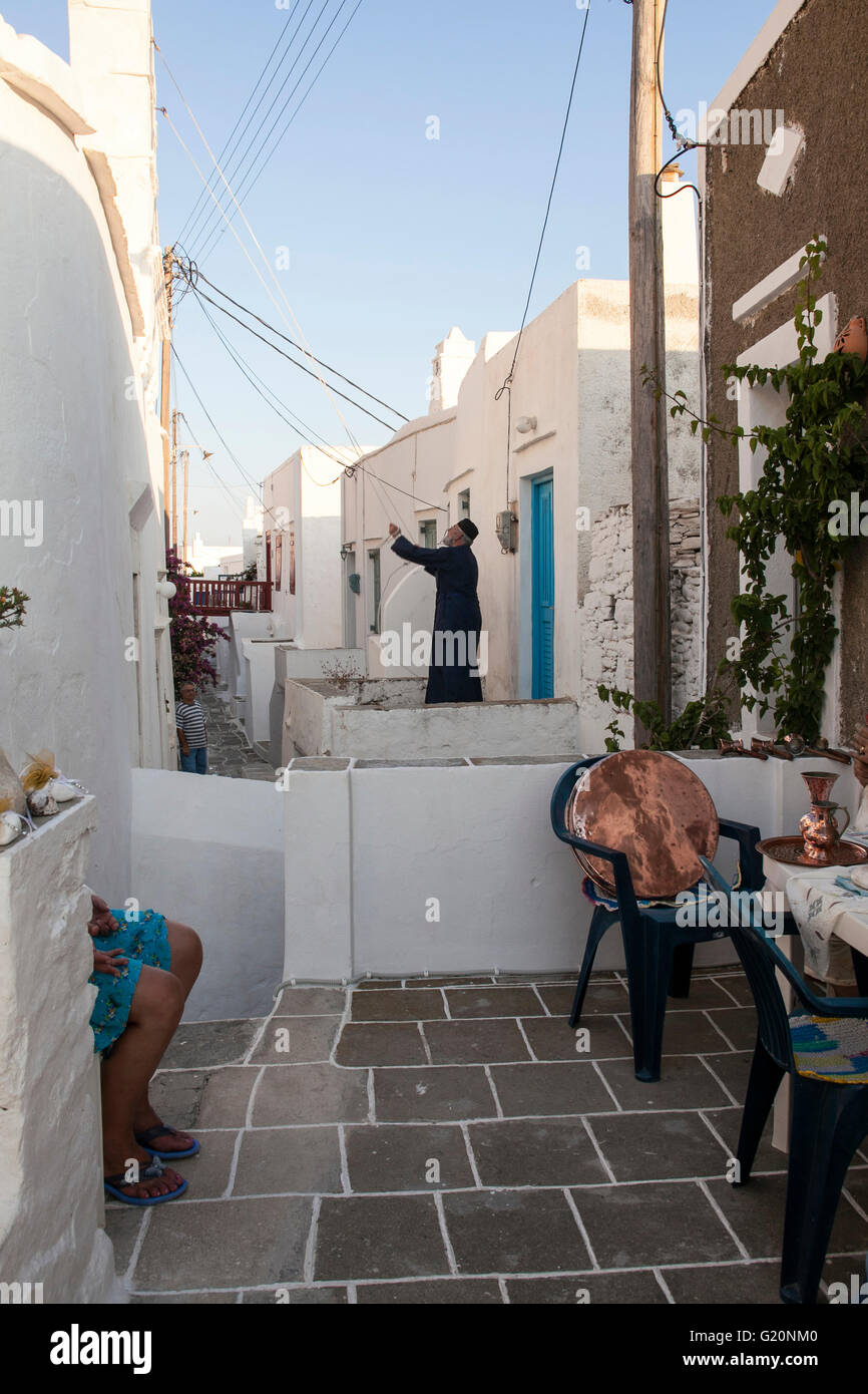 Old Christian Orthodox priest ringing the church bells, Sifnos island ...