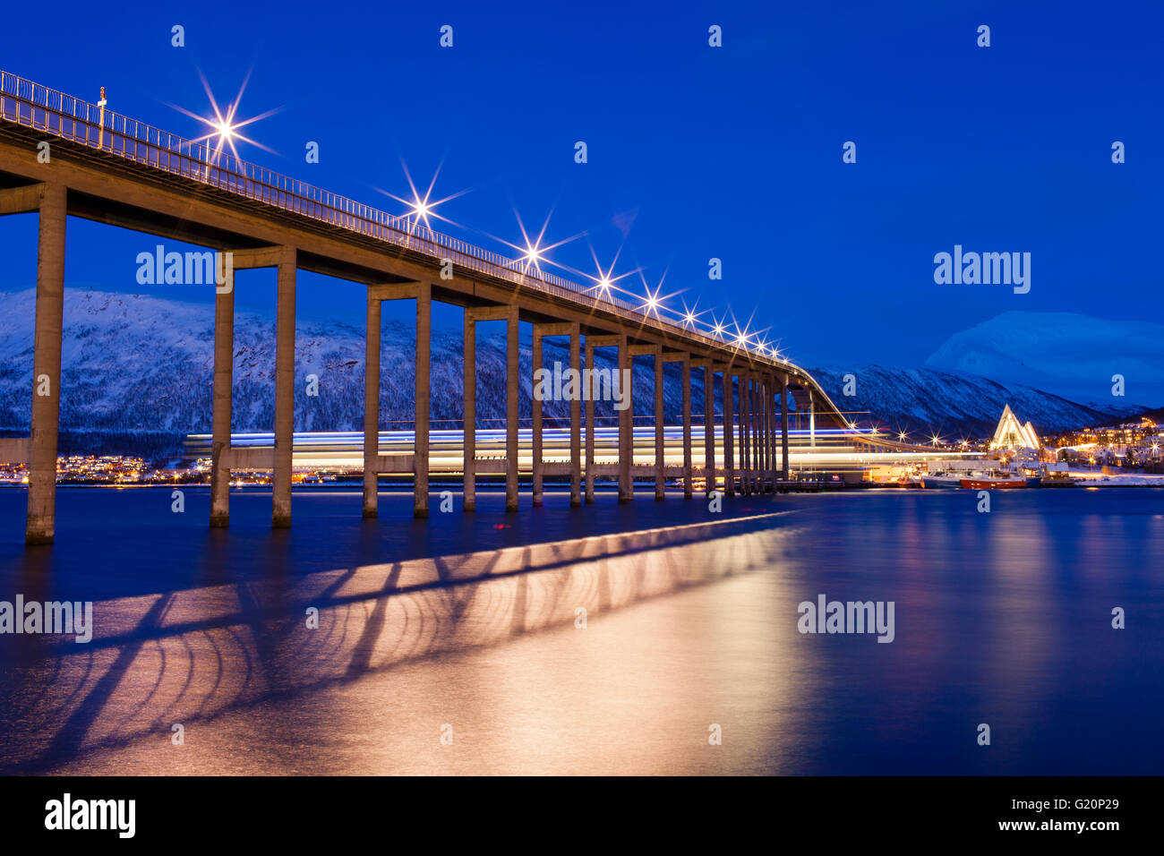 Tromsø (Tromso) Bridge at night, light from a ferry passing under is ...