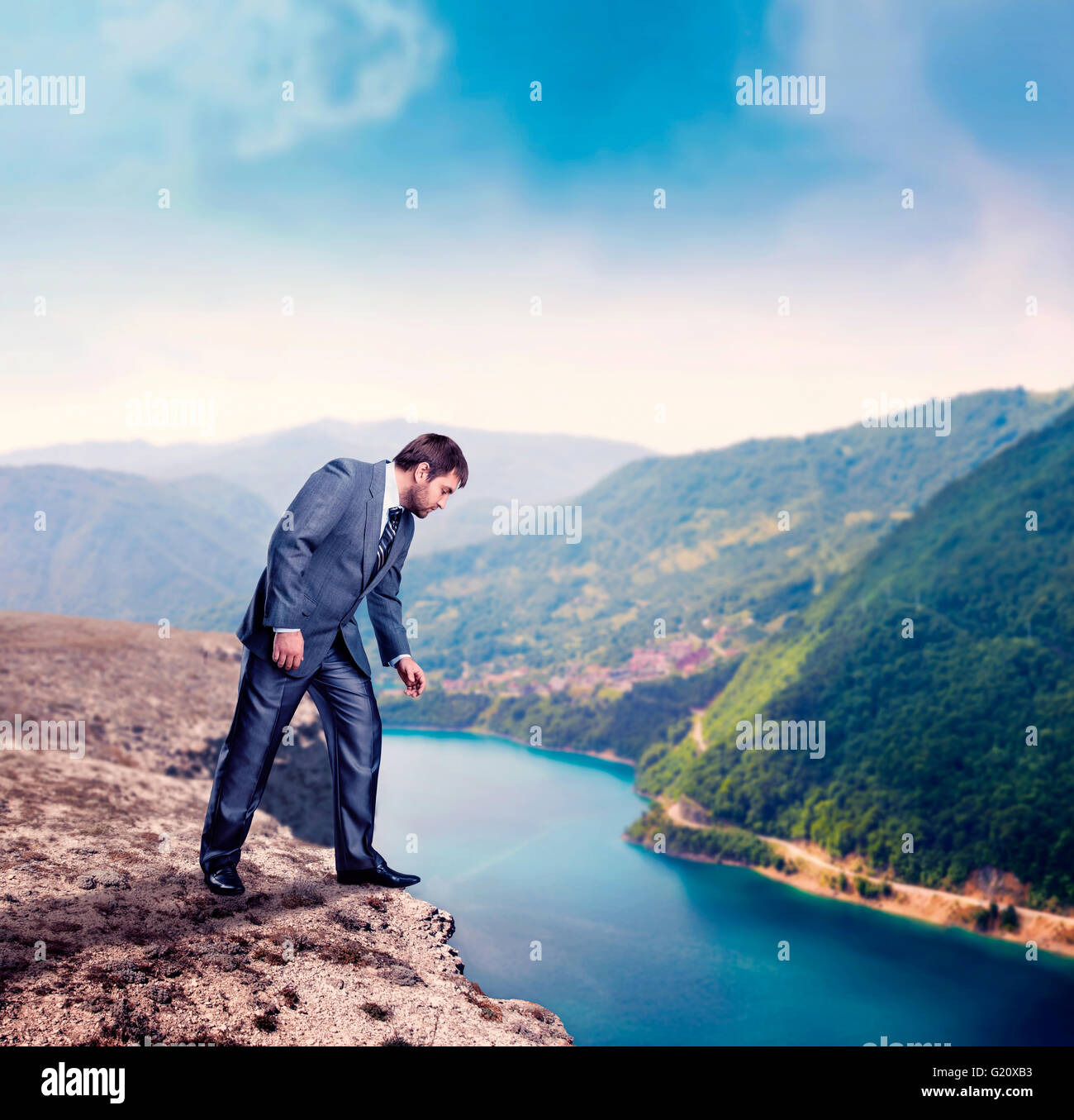 Businessman on the mountain edge Stock Photo - Alamy