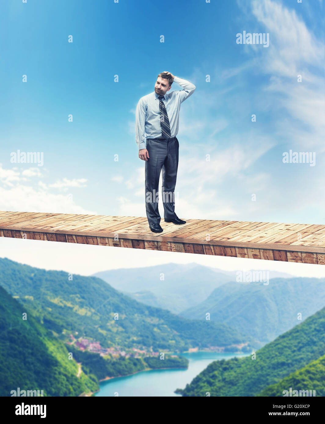 Man on the bridge above the mountain river Stock Photo - Alamy