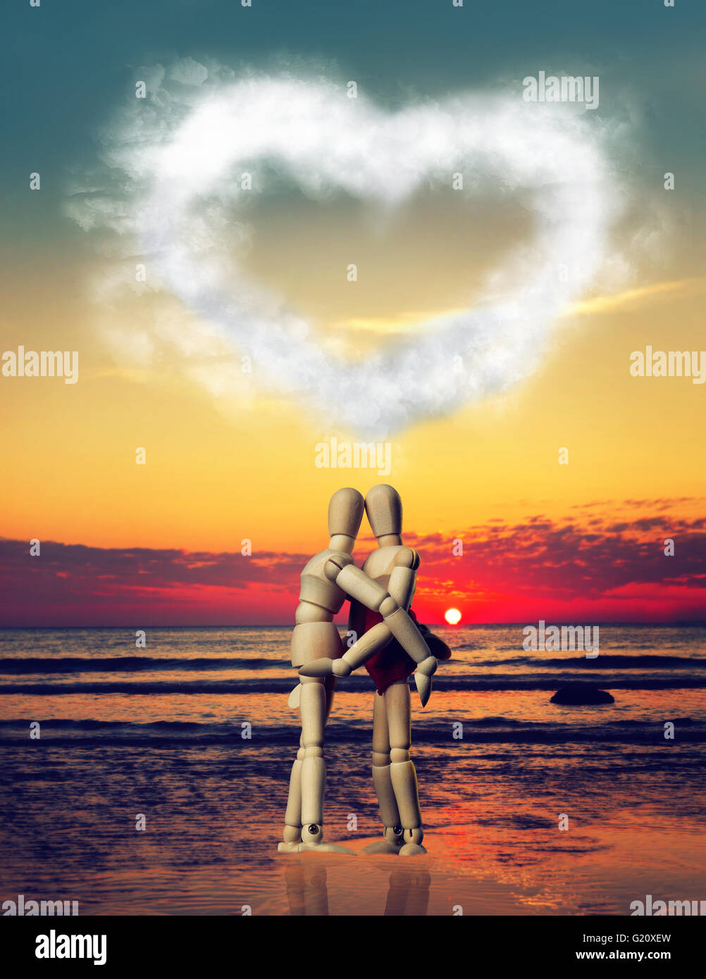 Couple of wooden figures hugging Stock Photo - Alamy