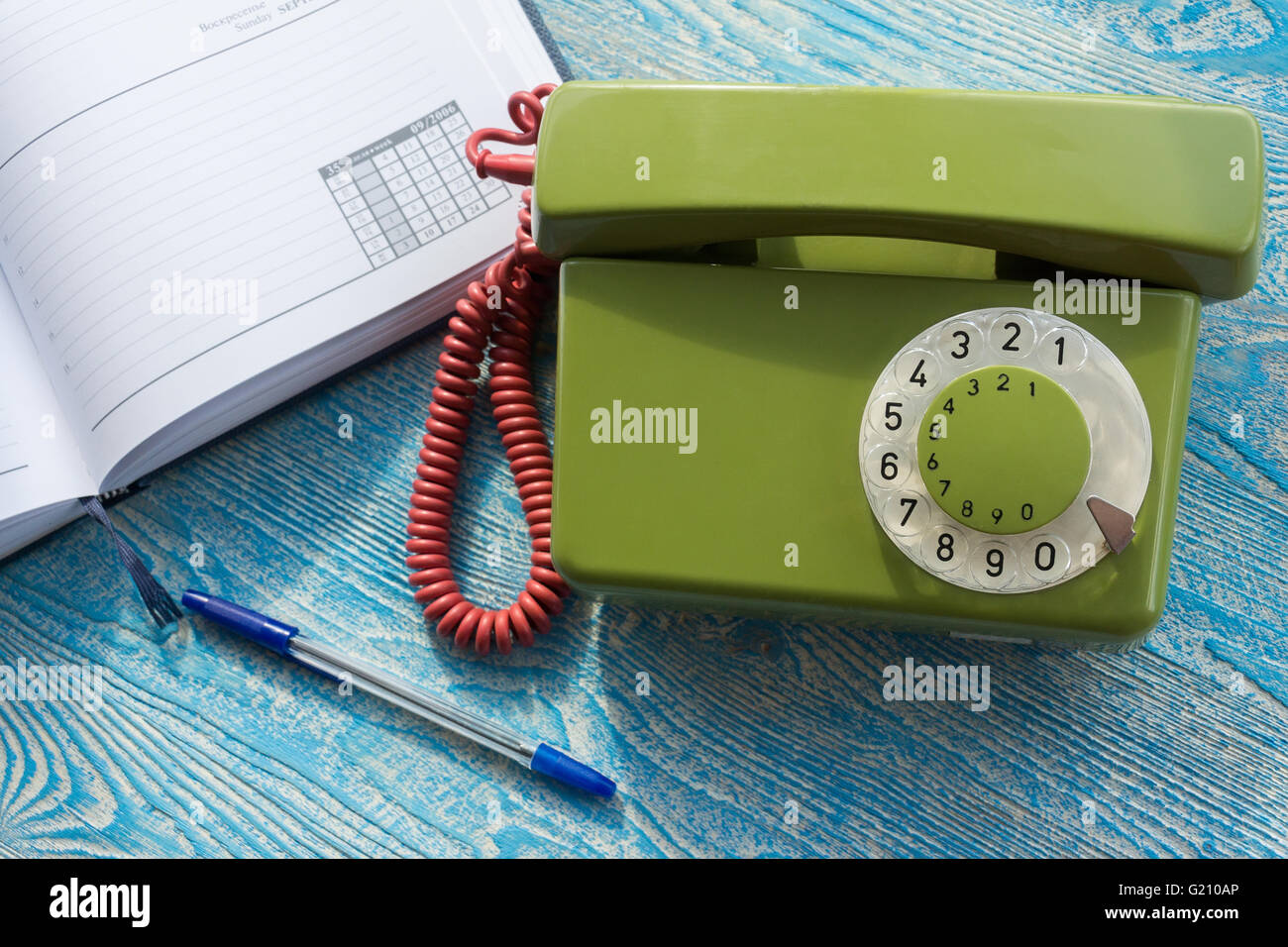 The photo depicts a landline phone with a notebook Stock Photo - Alamy