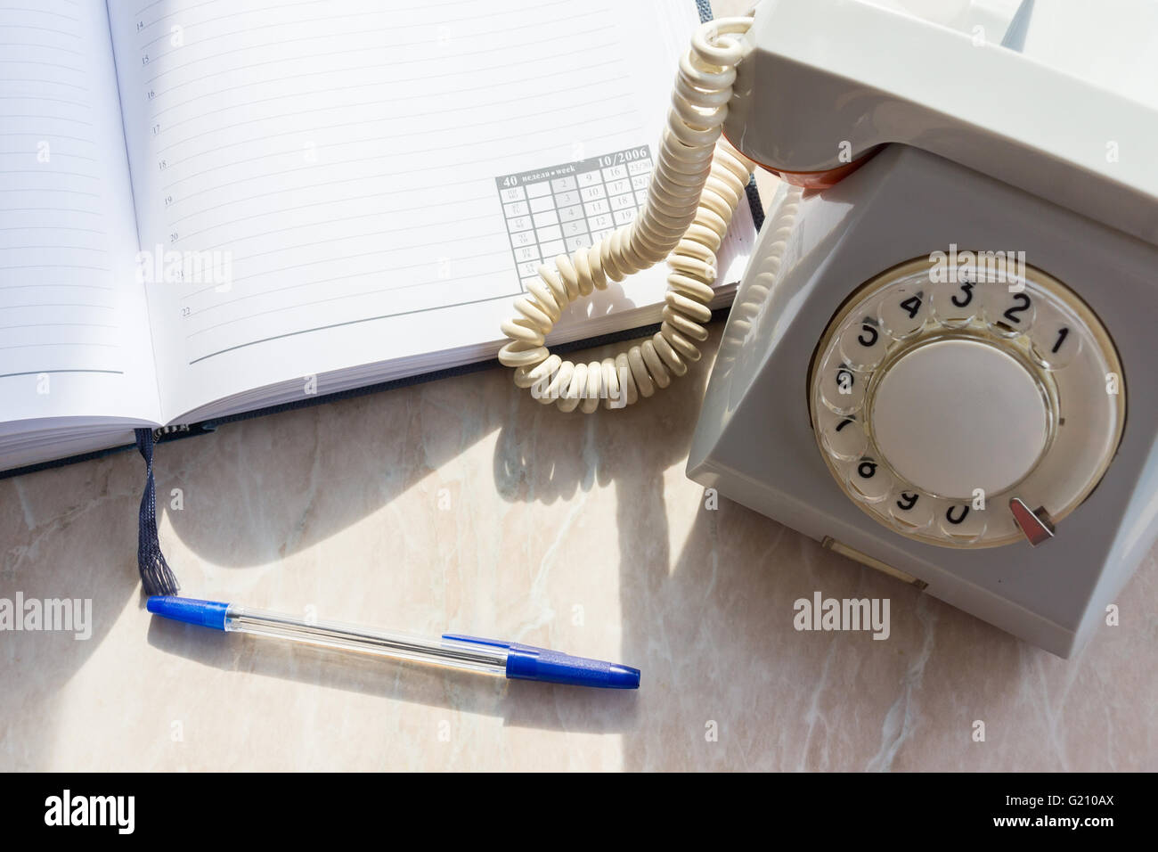 The photo depicts a landline phone with a notebook Stock Photo - Alamy