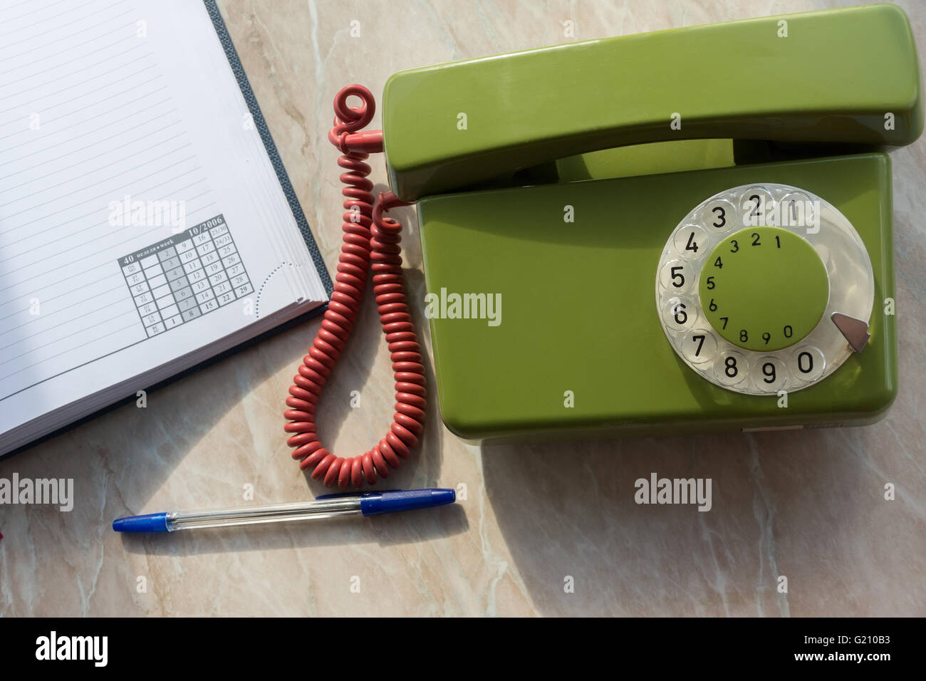The photo depicts a landline phone with a notebook Stock Photo - Alamy