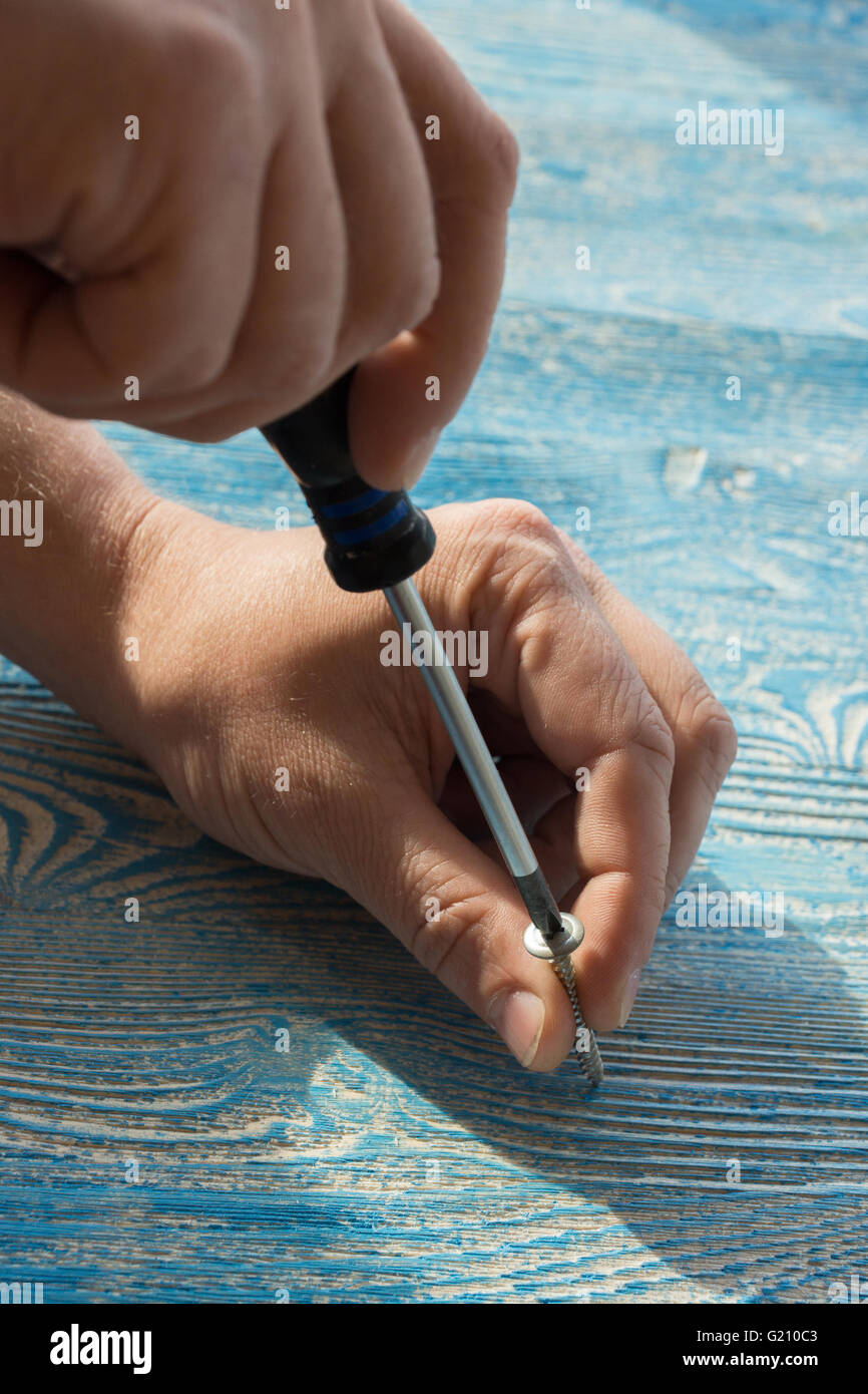 The photo shows a hand with a screwdriver Stock Photo - Alamy