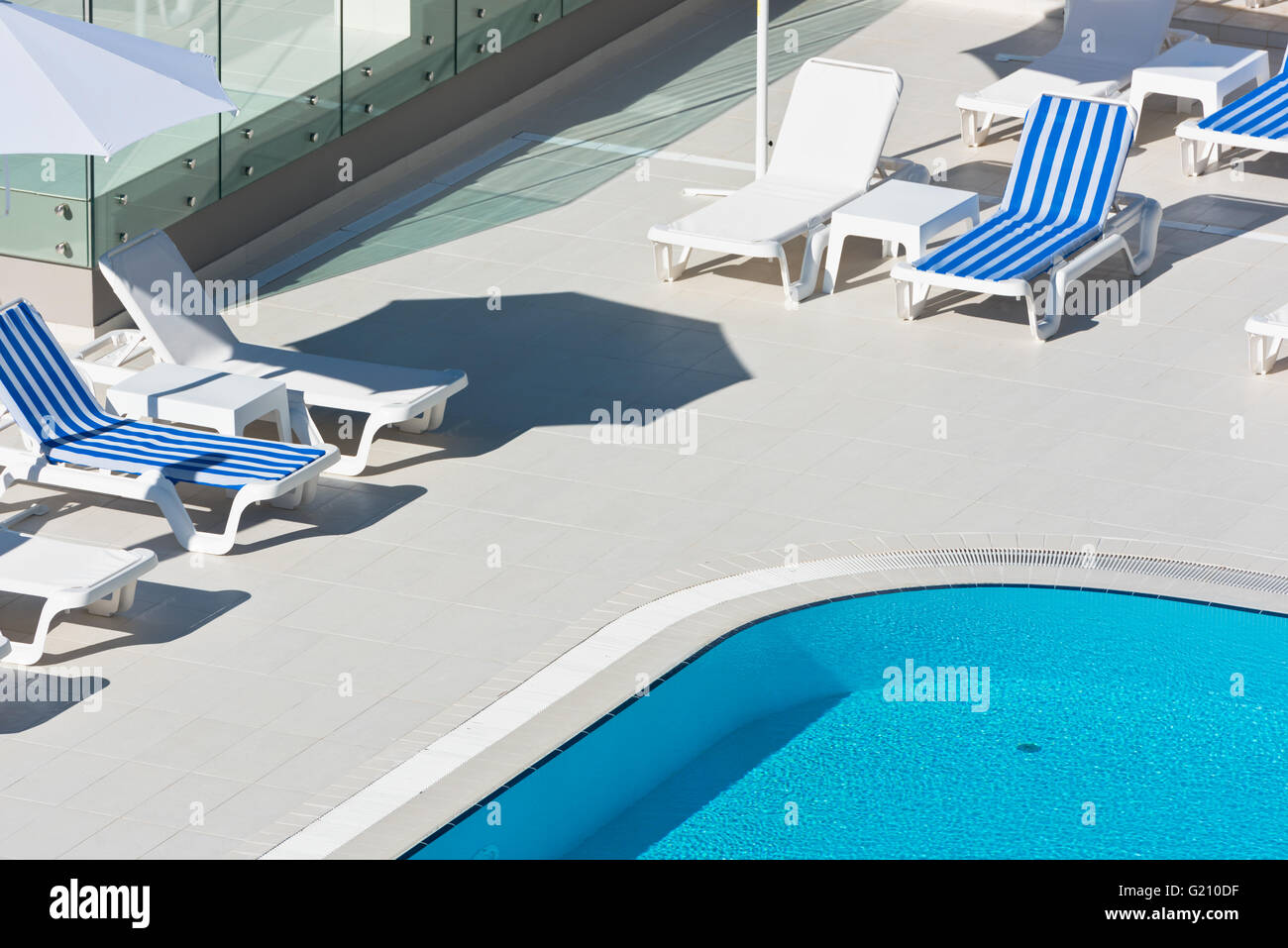 Hotel Poolside Chairs near a swimming pool. Summer shot Stock Photo - Alamy