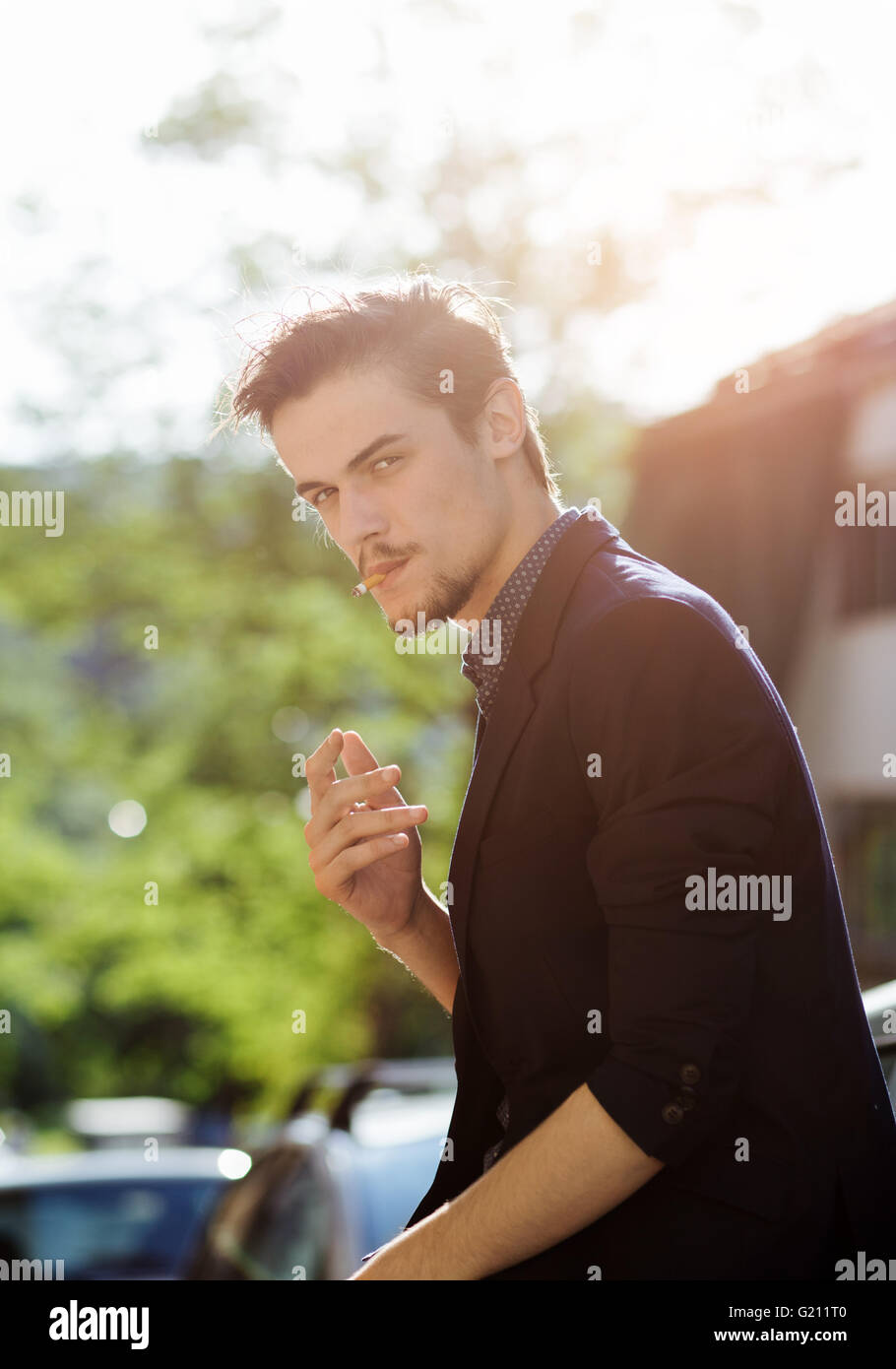 Portrait of man smoking a cigarette Stock Photo - Alamy
