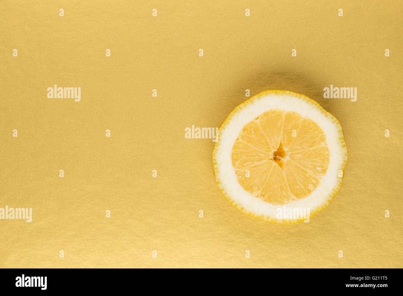 Yellow lemon on a gold background Stock Photo - Alamy