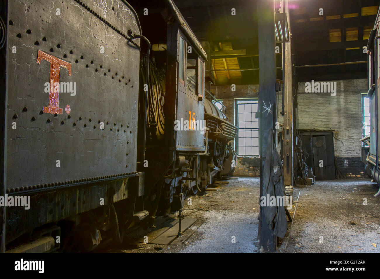 Vintage locomotive engines and cars in old roundhouse Stock Photo - Alamy