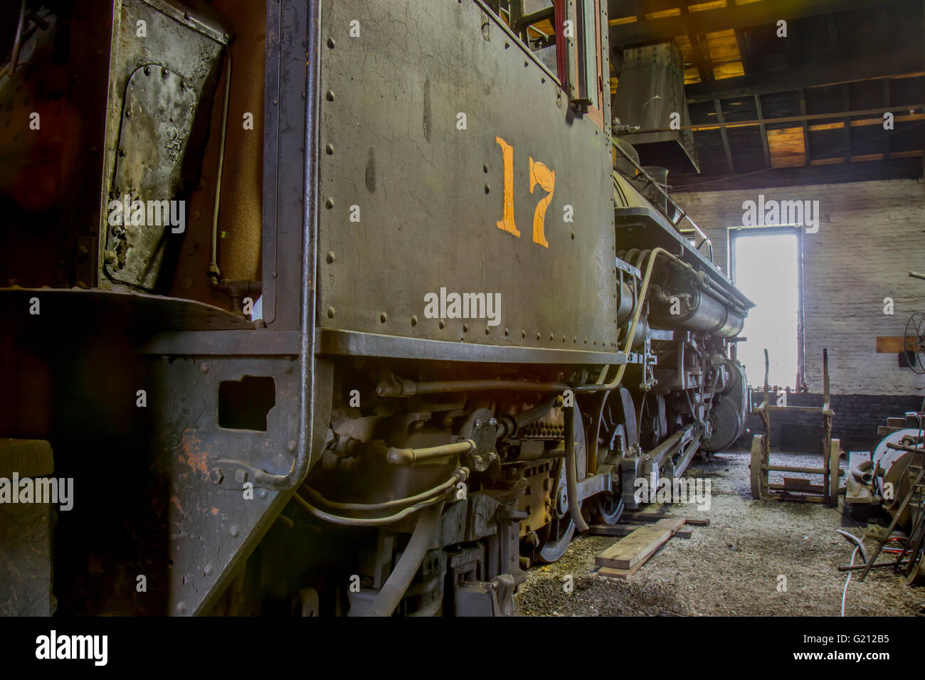 Vintage train engine in roundhouse workroom Stock Photo - Alamy