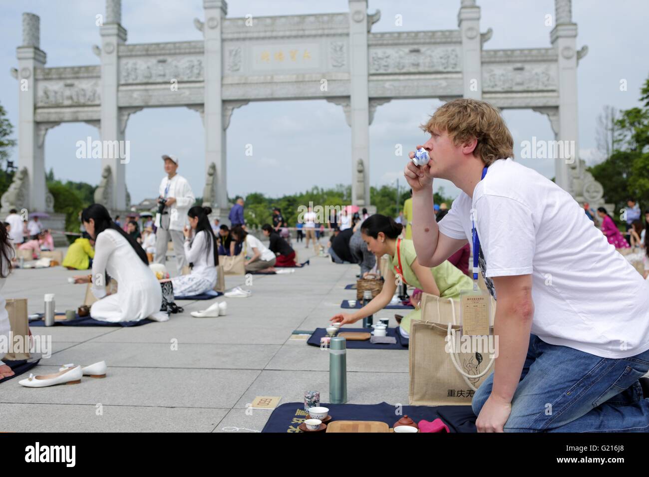 Chongqing, China. 21st May, 2016. A foreigner drinks a cup of tea ...