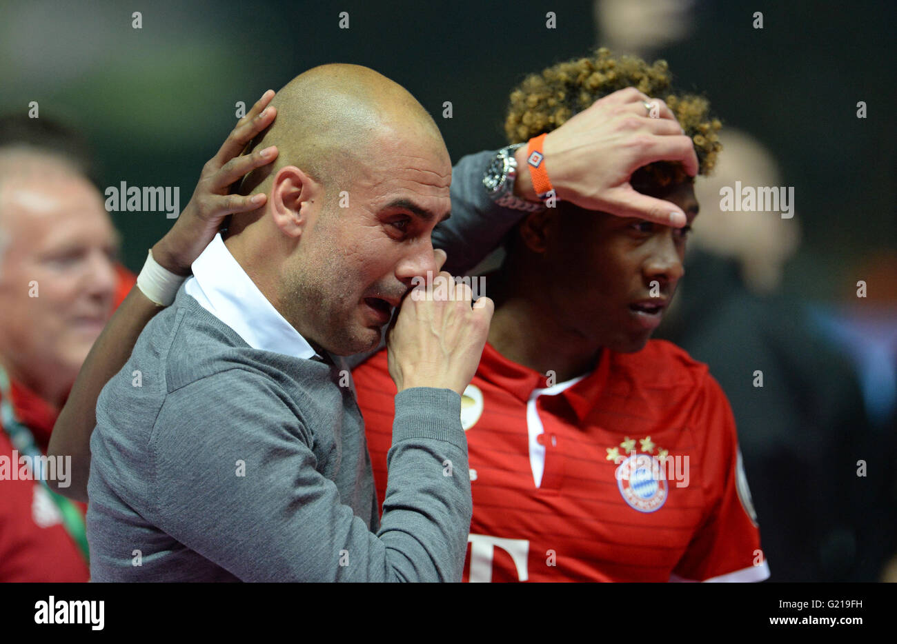 Munich's head coach Josep 'Pep' Guardiola (C-L) is moved to tears as he ...
