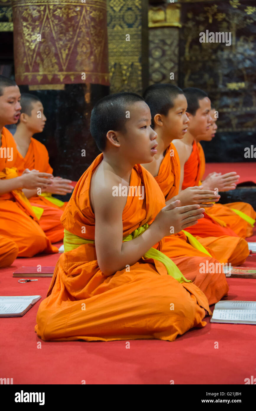 Buddhist monks praying in temple hi-res stock photography and images ...
