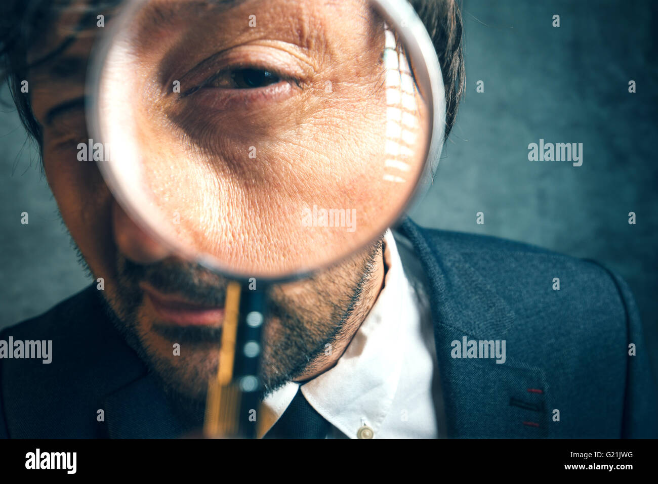 Enlarged eye of tax inspector looking through magnifying glass ...