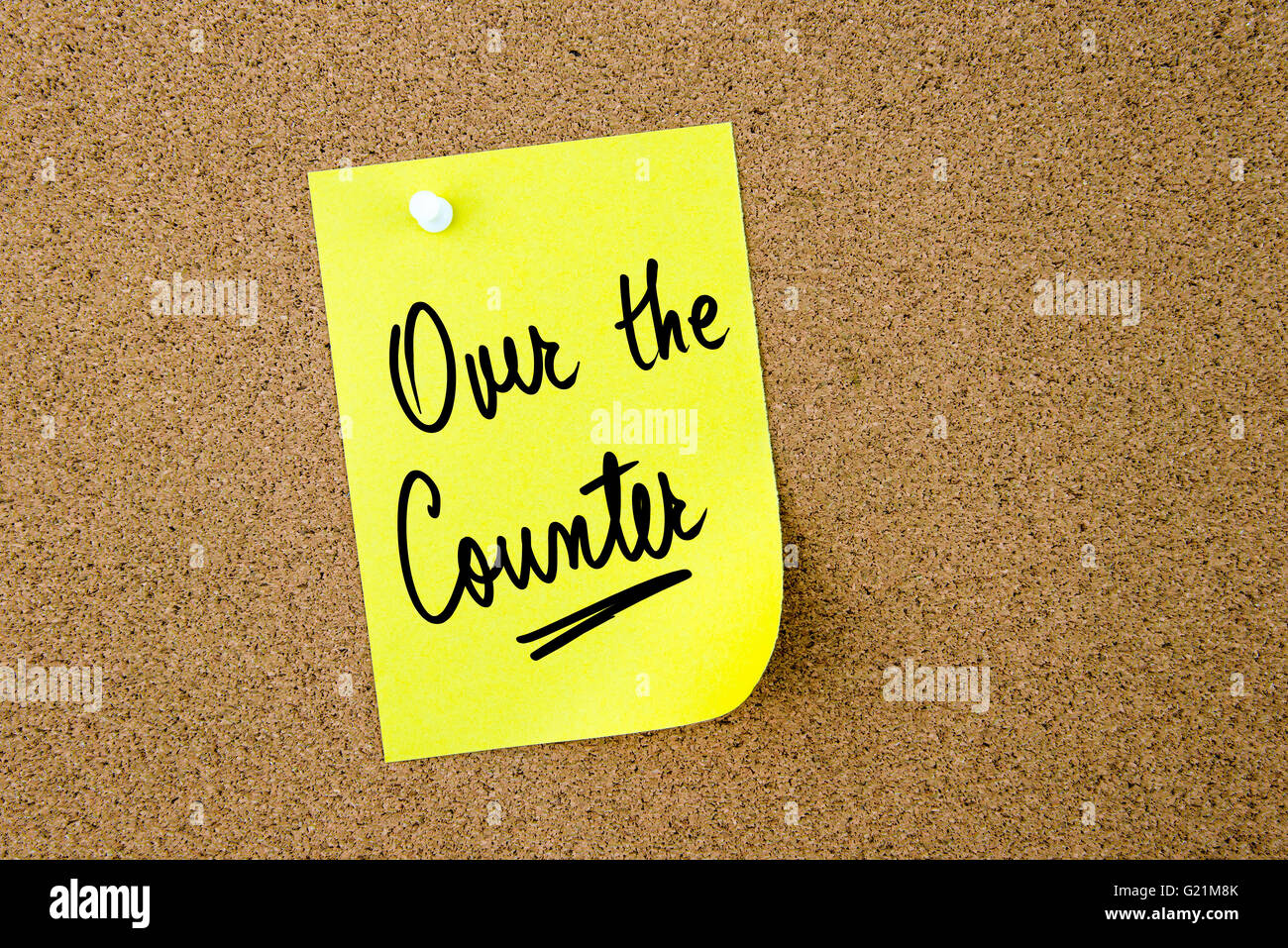 Over The Counter written on yellow paper note pinned on cork board with ...