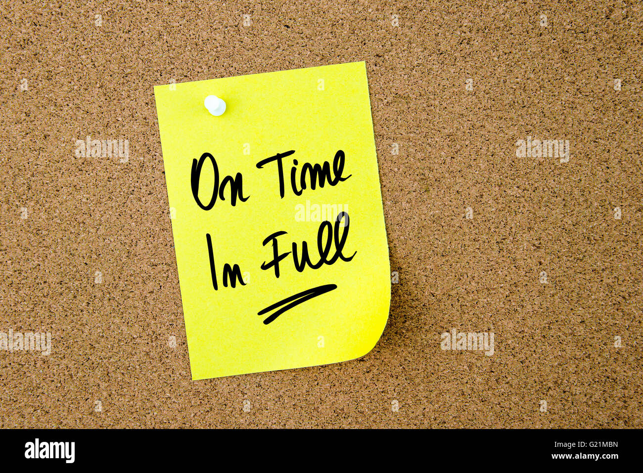 On Time In Full written on yellow paper note pinned on cork board with ...