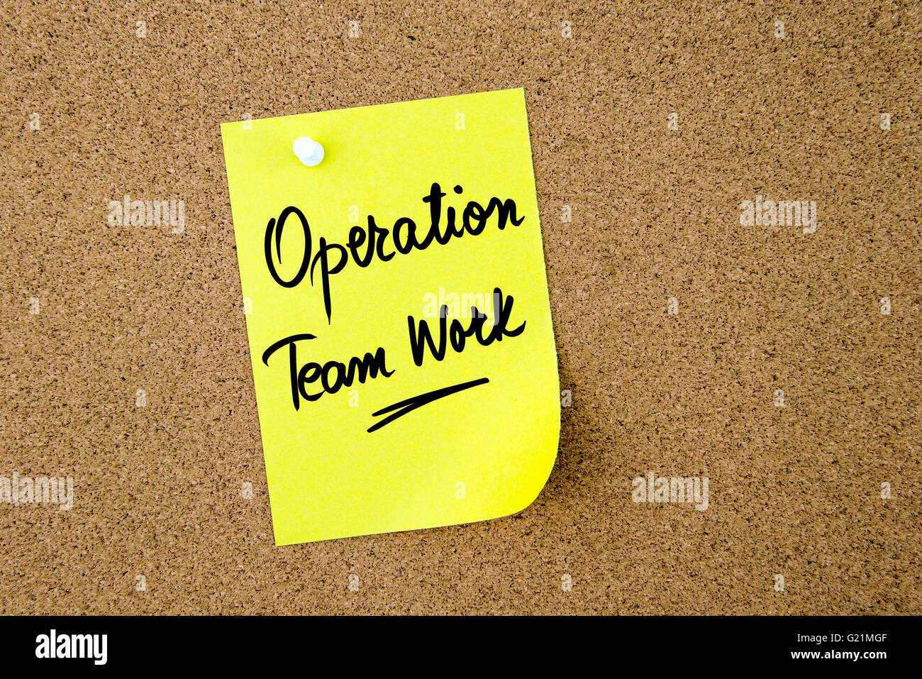 Operation Team Work written on yellow paper note pinned on cork board ...