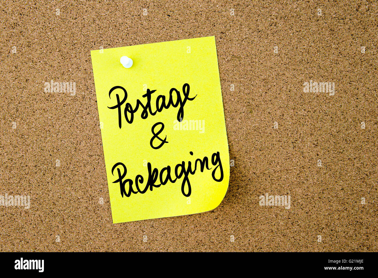 Postage and Packaging written on yellow paper note pinned on cork board ...