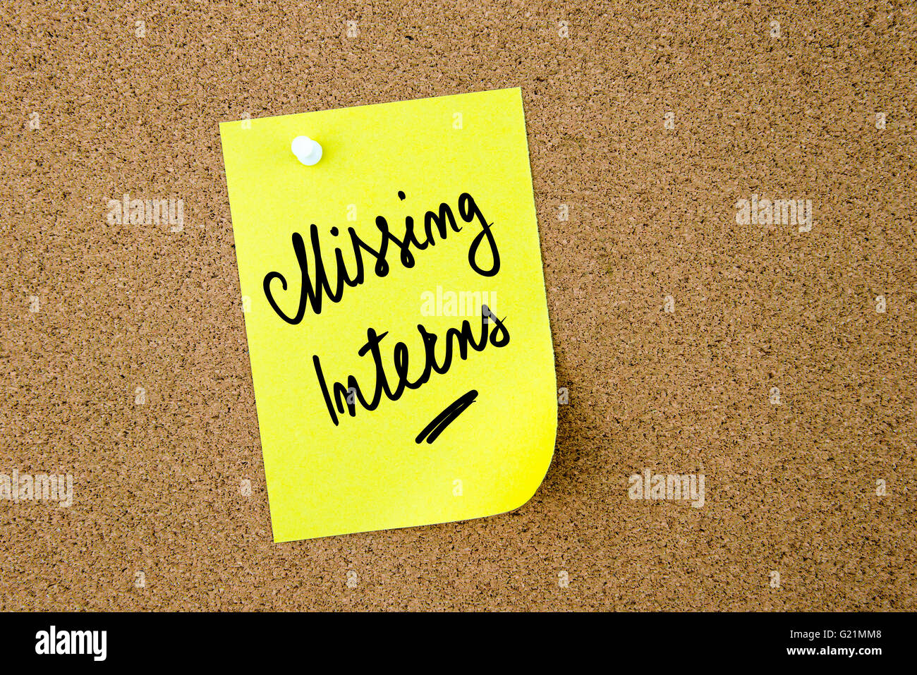 Missing Interns written on yellow paper note pinned on cork board with ...