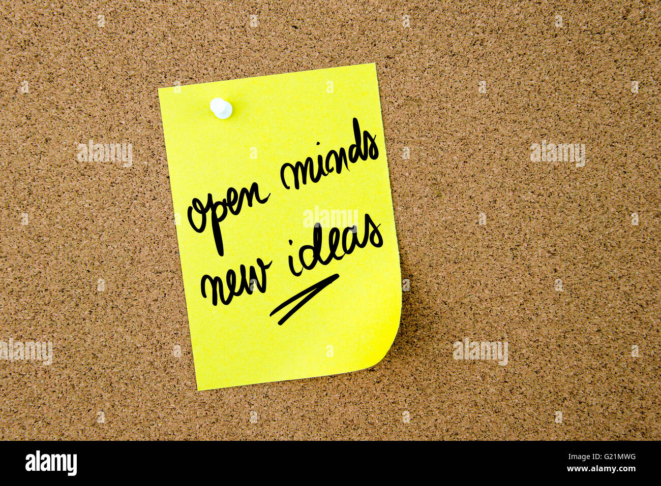 Open Minds New Ideas written on yellow paper note pinned on cork board ...