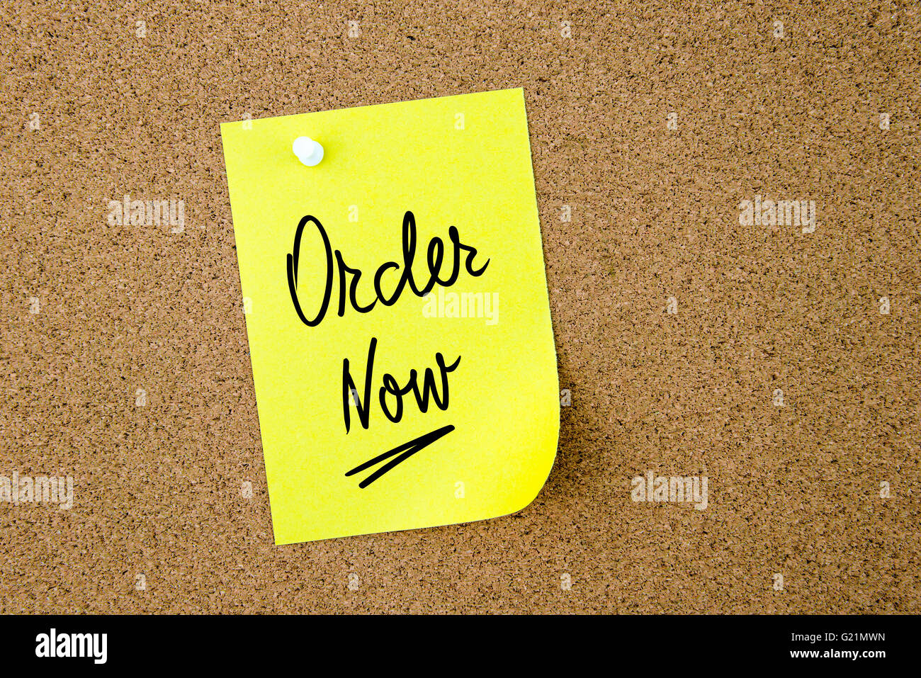Order Now written on yellow paper note pinned on cork board with white ...