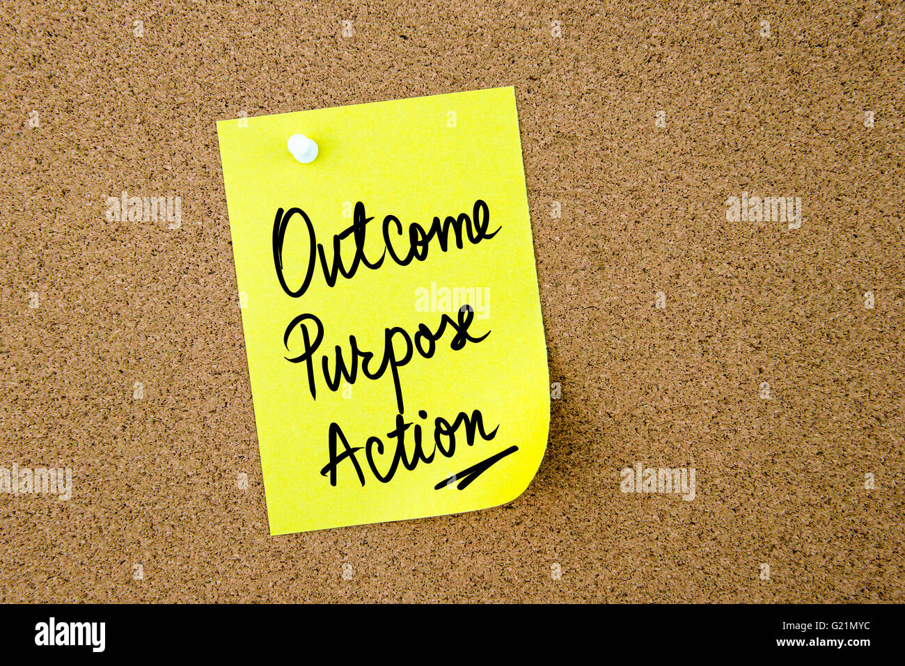 Outcome Purpose Action written on yellow paper note pinned on cork ...