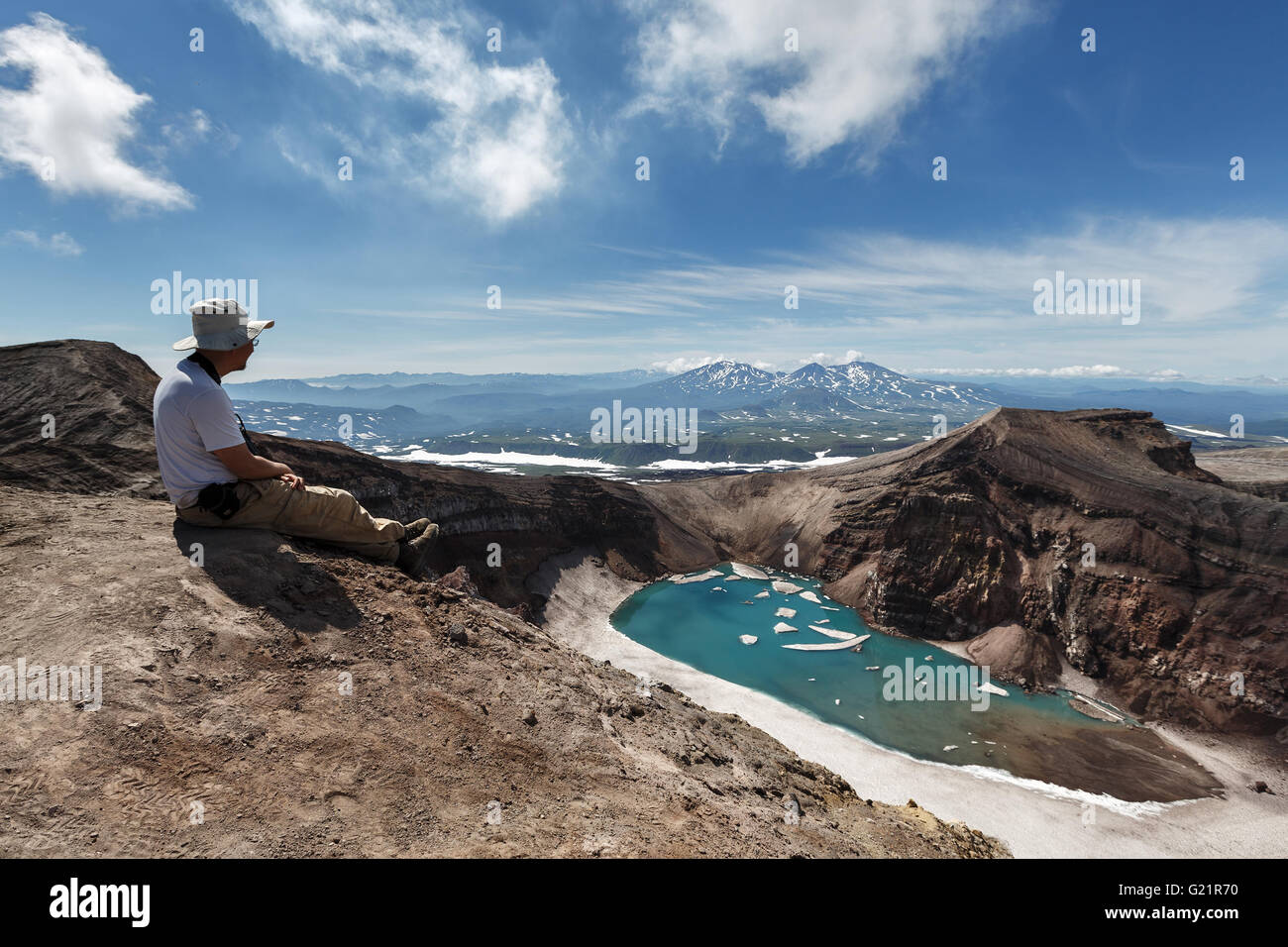 Tourist in the crater of active Gorely Volcano watching at beautiful ...