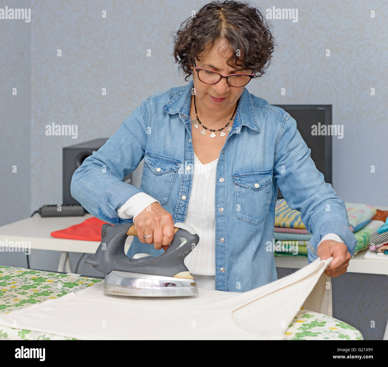 a charming woman doing the ironing Stock Photo - Alamy