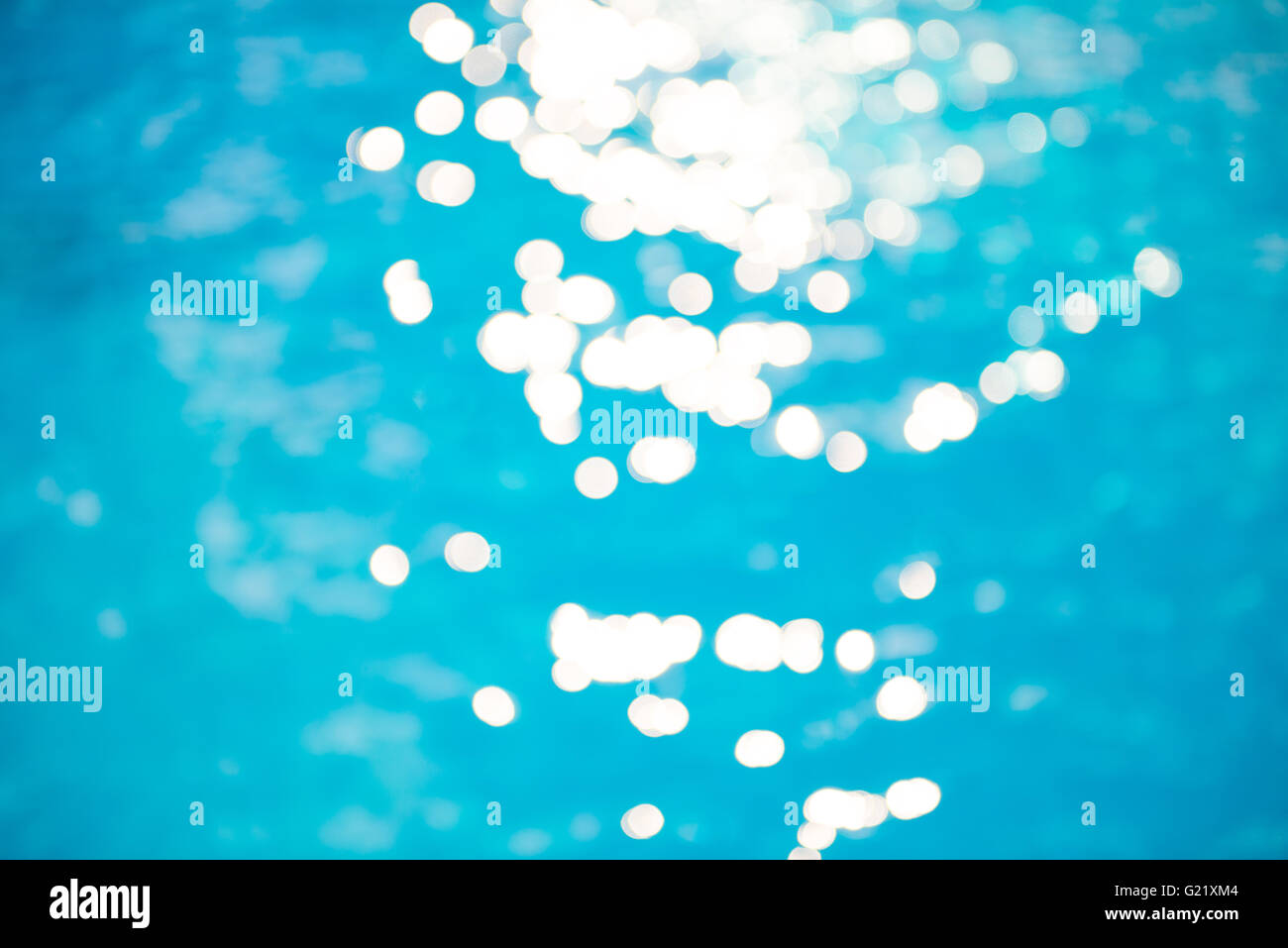 Soft focus bokeh light effects over a rippled, blue water background in the pool Stock Photo - Alamy