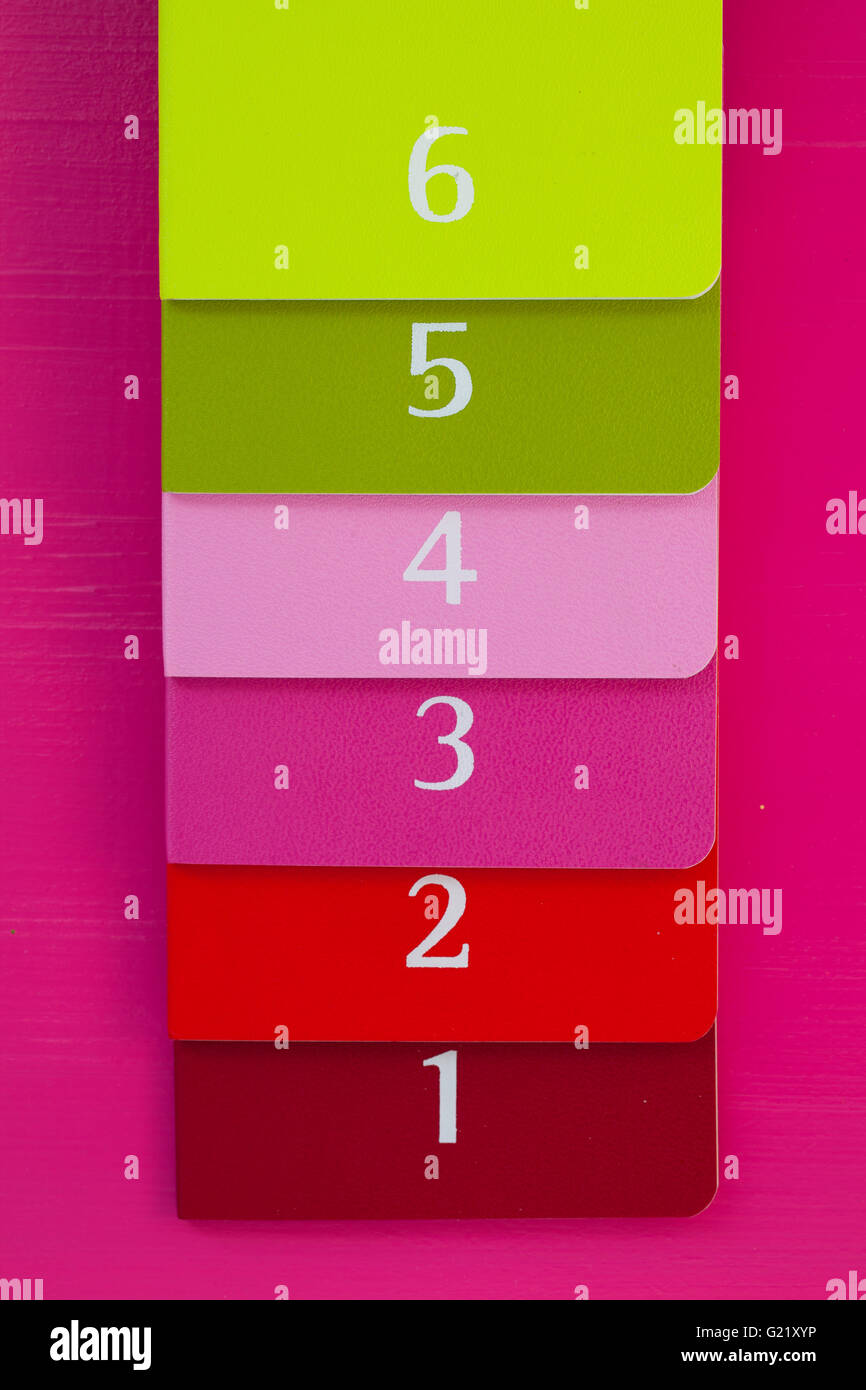 Six different color diaries on a pink wooden table Stock Photo - Alamy