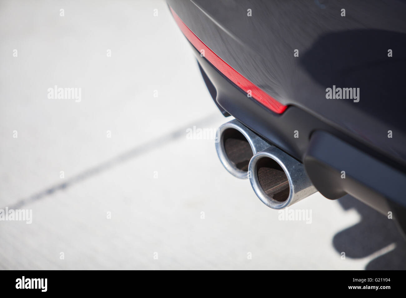 Detail of the double exhaust of a car Stock Photo - Alamy