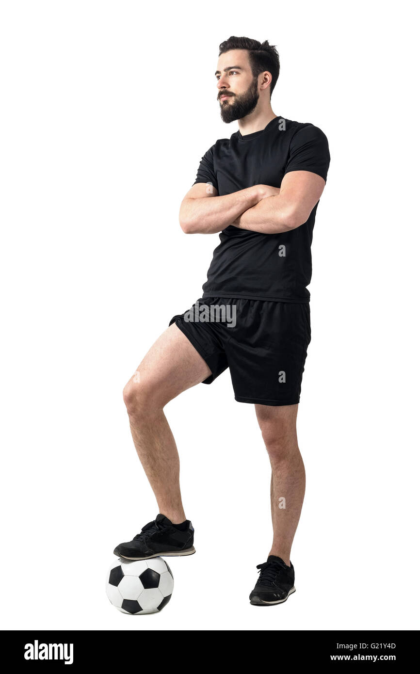 Confident soccer player with crossed arms looking away. Full body ...