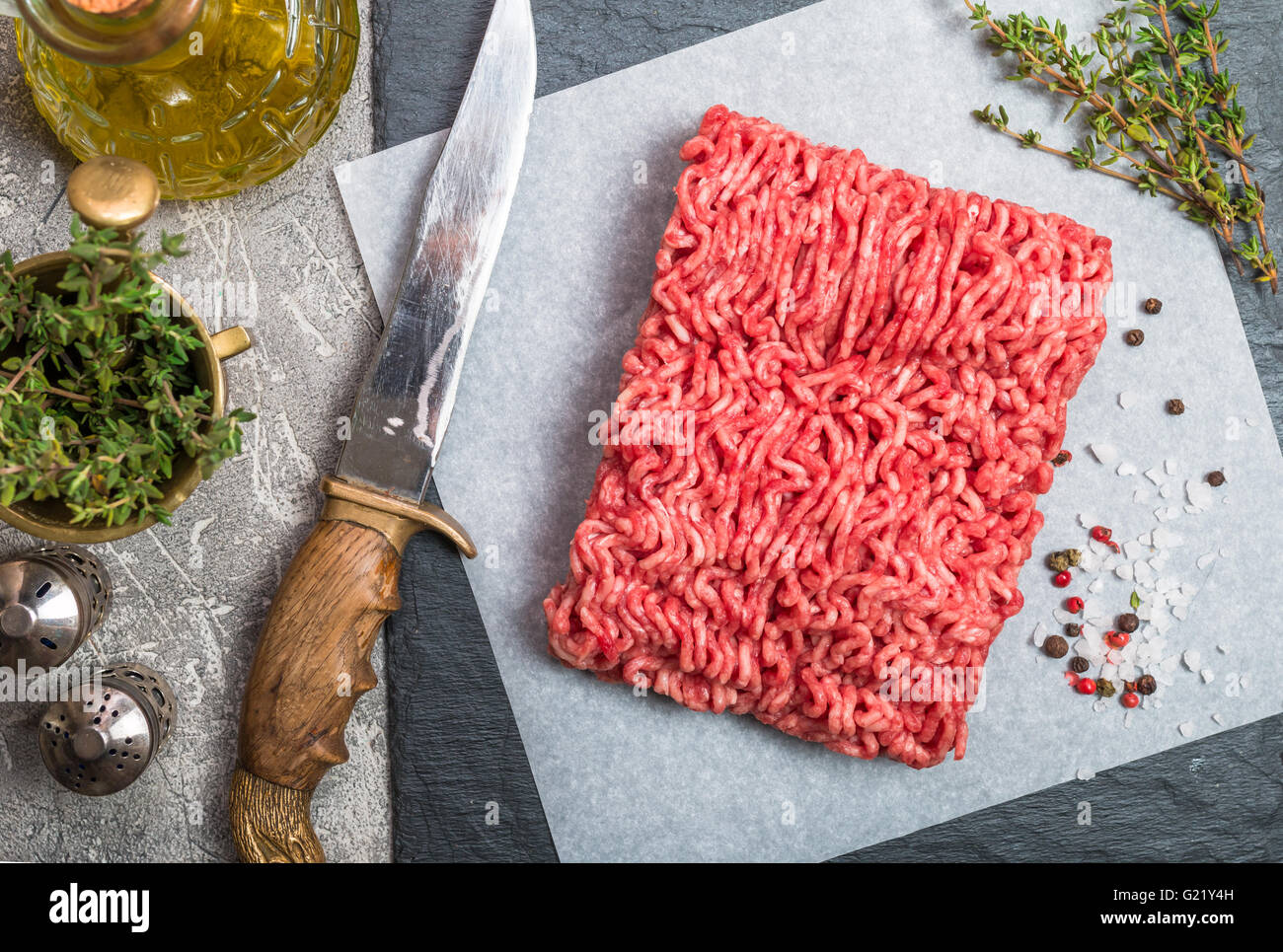 Minced meat with seasoning and fresh thyme Stock Photo - Alamy