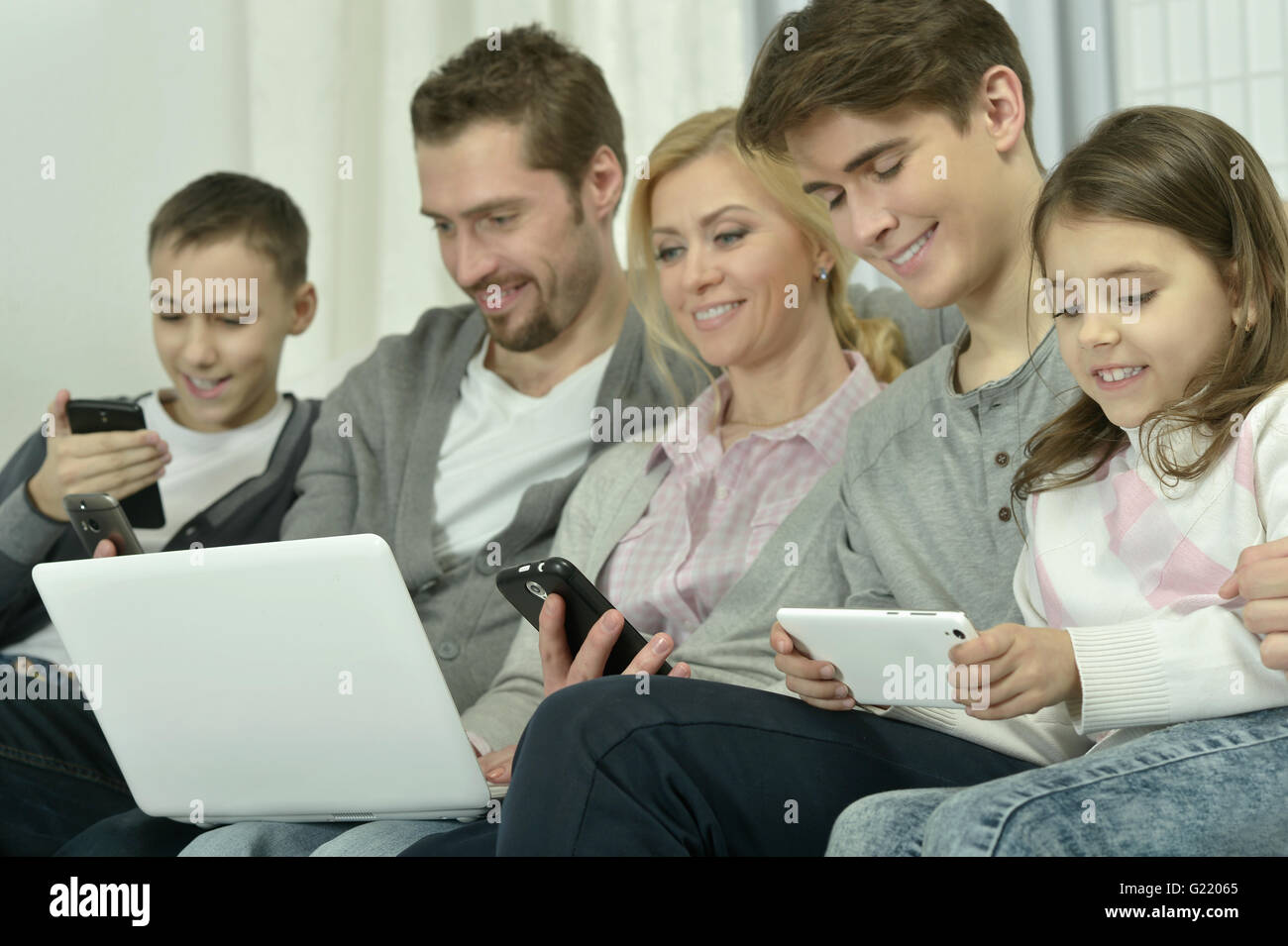 happy family with electronic gadgets Stock Photo - Alamy