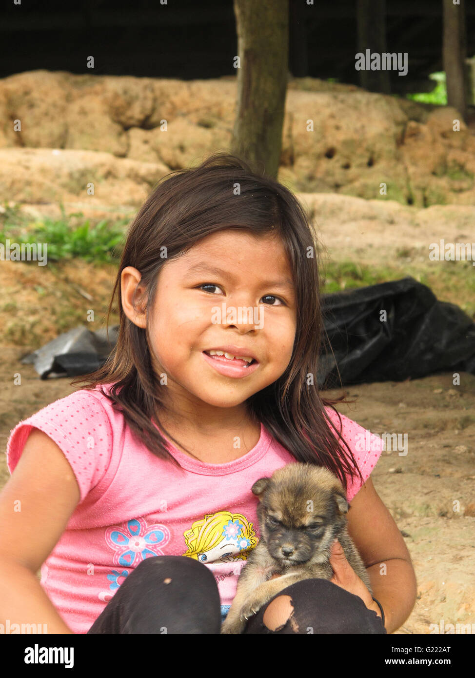 Little girl with her puppy. Angamos. Amazon river. Peru Stock Photo - Alamy