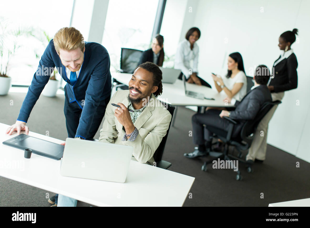 Businessmen working together at the desk in the office Stock Photo - Alamy