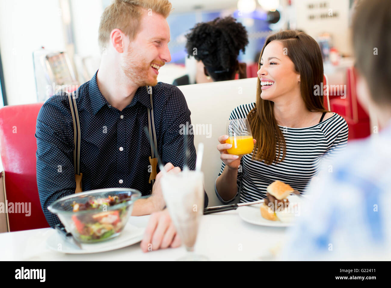 Friends eating at the table in the diner Stock Photo - Alamy