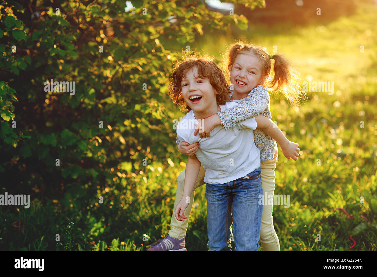 Boy and girl playing in the summer park Stock Photo - Alamy