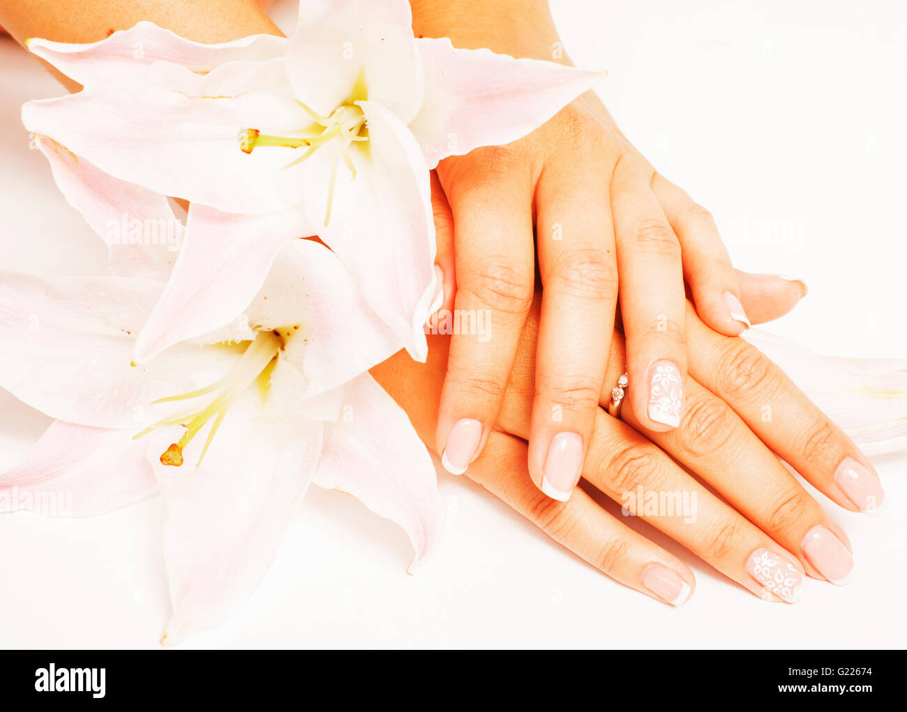 beauty delicate hands with manicure holding flower lily close up ...