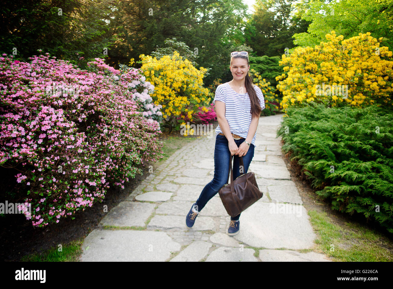 Girl standing on the footpath in the park Stock Photo - Alamy