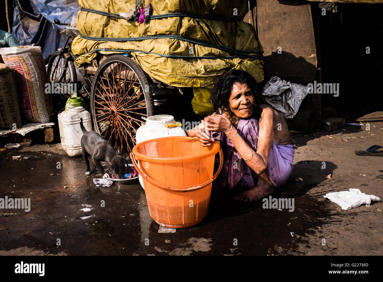 Woman using a bucket for washing, Delhi, India Stock Photo - Alamy