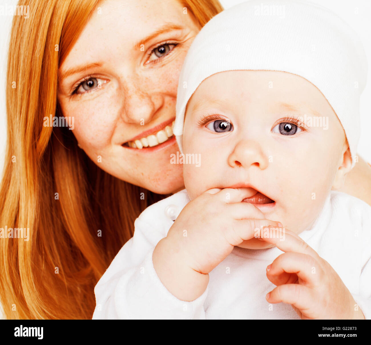 young beauty mother with baby, red head happy family isolated close up ...