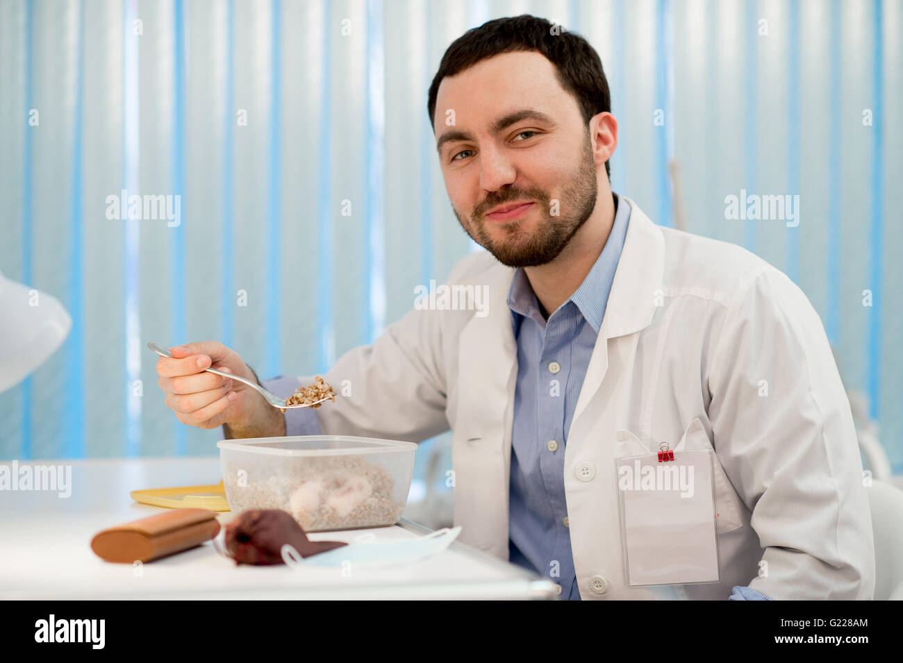 Doctor having a lunch at his office during the break. Employee eating ...