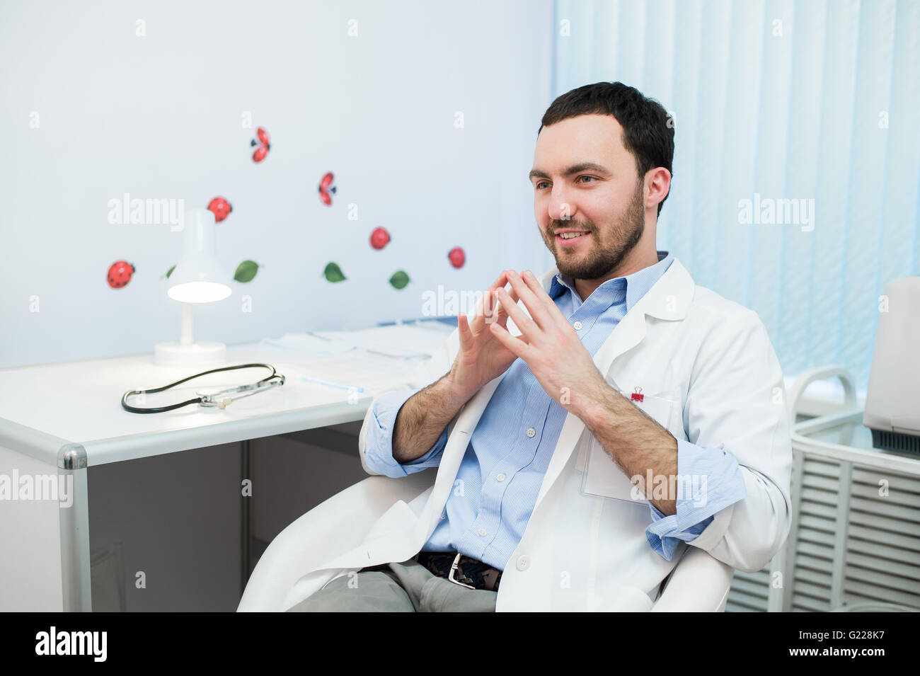 Doctor in consultation with patient sitting in front of him Stock Photo ...