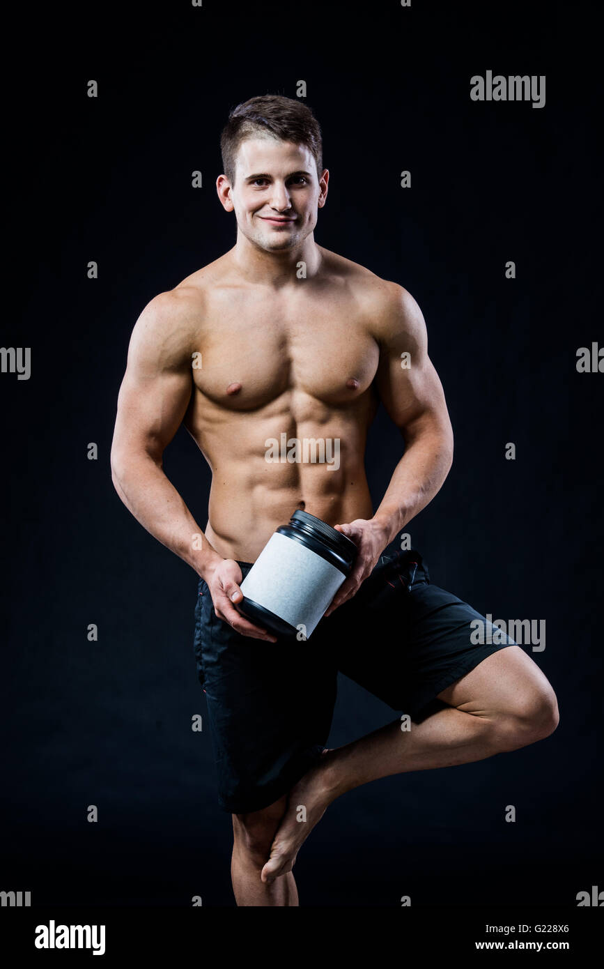 Bodybuilding and Sports theme: handsome strong bodybuilder holding ...