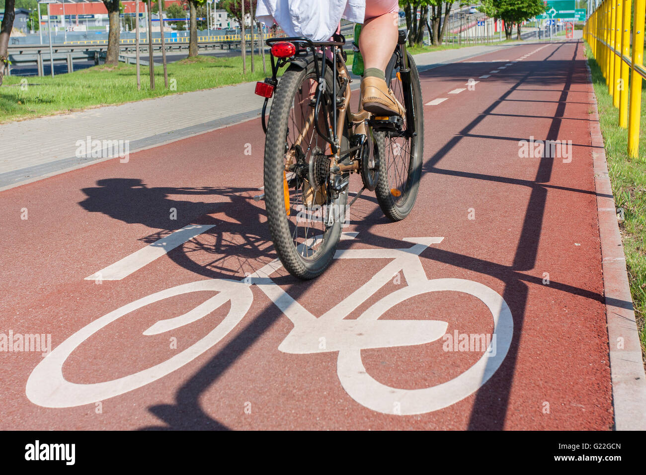 Bicycle road sign and bike riders, bicycle path in the city center ...