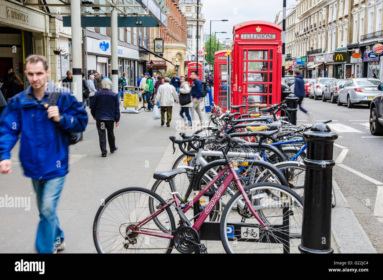 Red telephone boxes and bicycles outside Bayswater London Underground ...