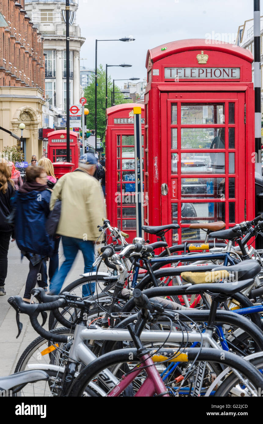Red telephone boxes and bicycles outside Bayswater London Underground ...